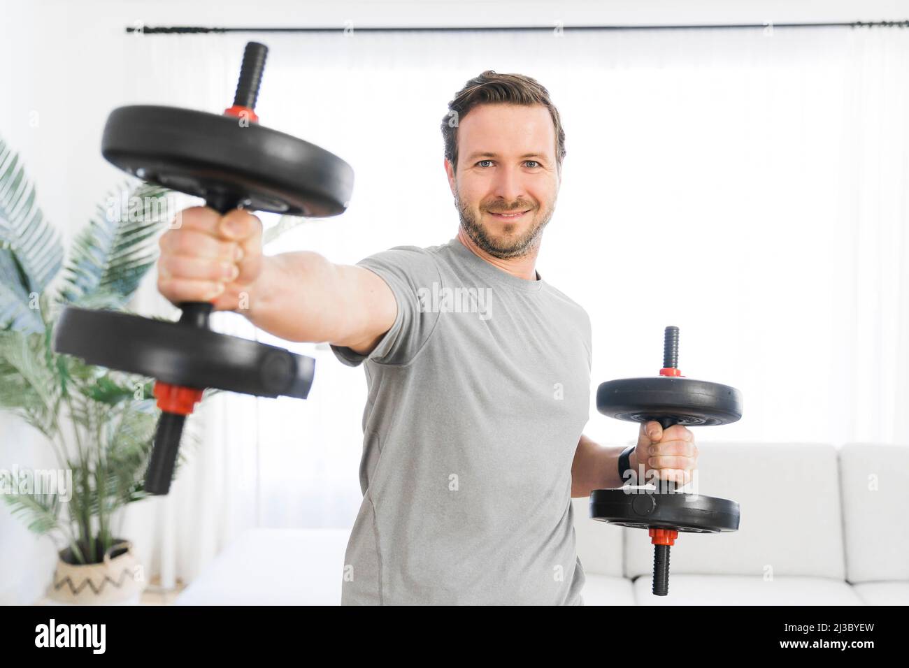Athletic man home dumbell hi-res stock photography and images - Alamy