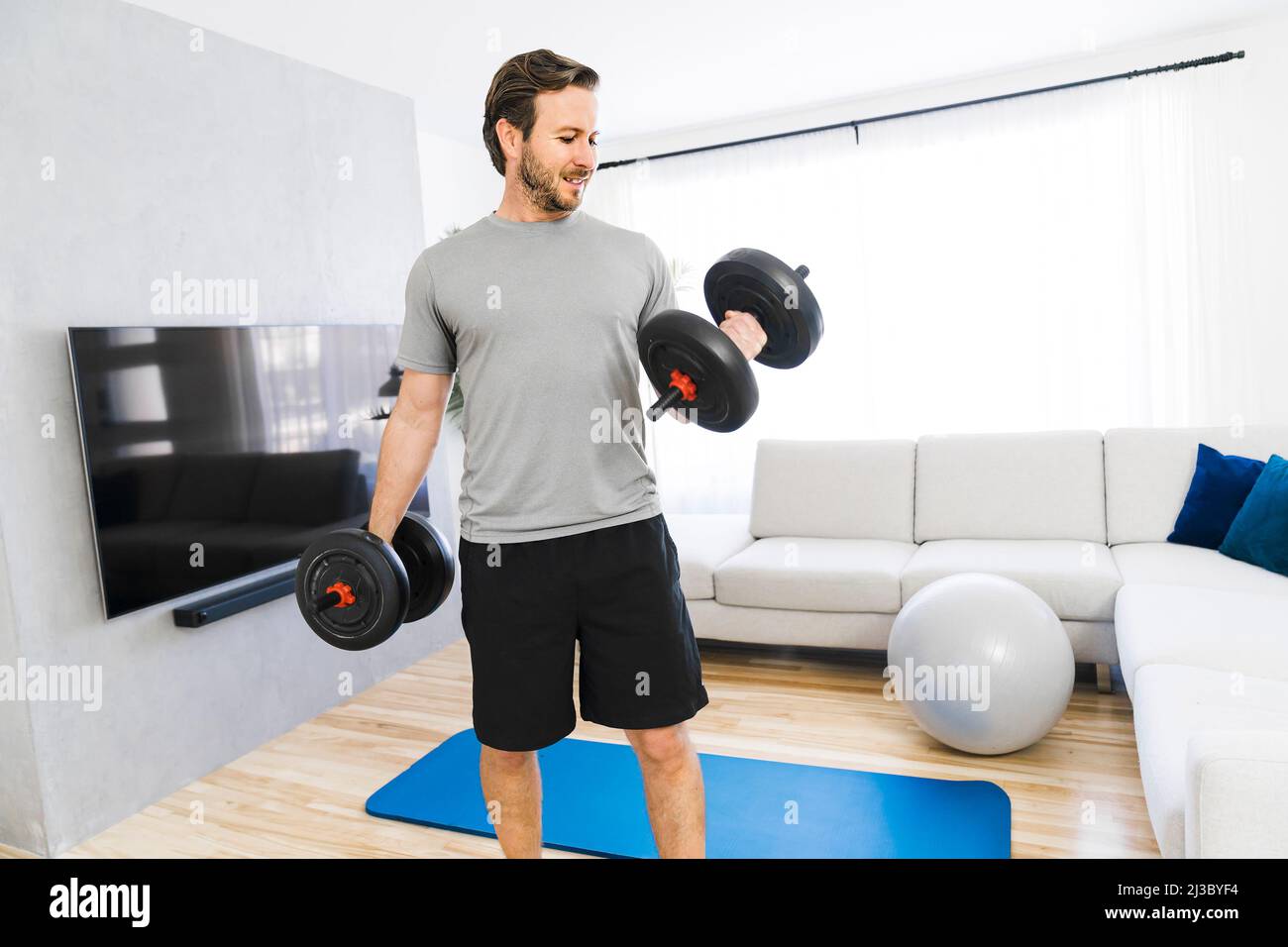 Athletic man home dumbell hi-res stock photography and images - Alamy
