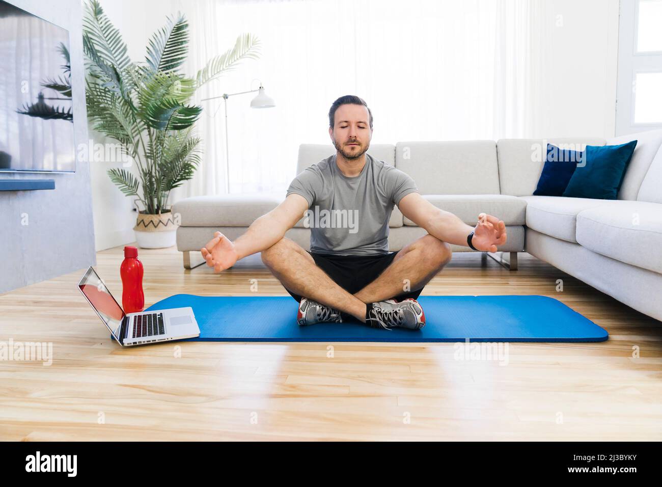 Attractive Fit man Exercise at home on the living room Stock Photo - Alamy