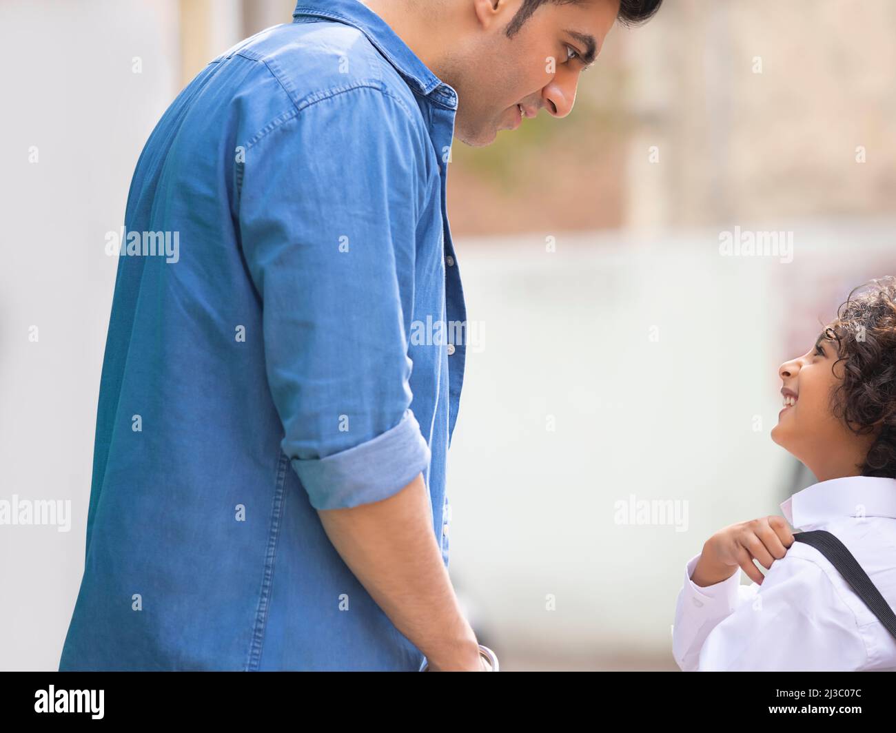 Portrait of school boy standing with his father Stock Photo - Alamy