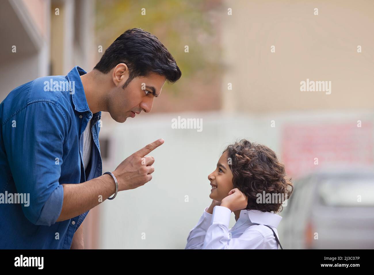 Little school boy apologizing to his father for the mistake Stock Photo ...