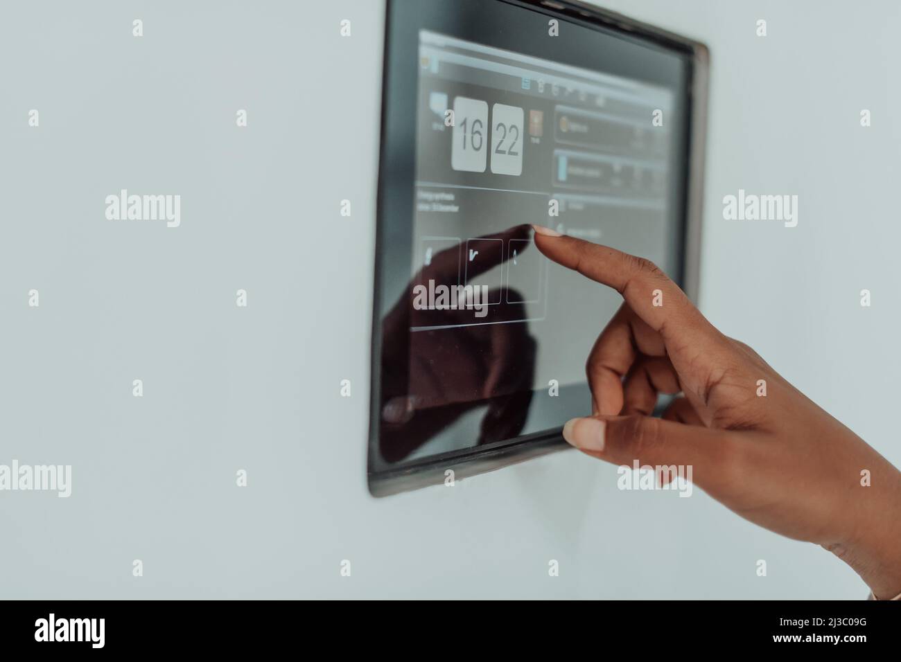 African woman using smart home screen control system Stock Photo - Alamy