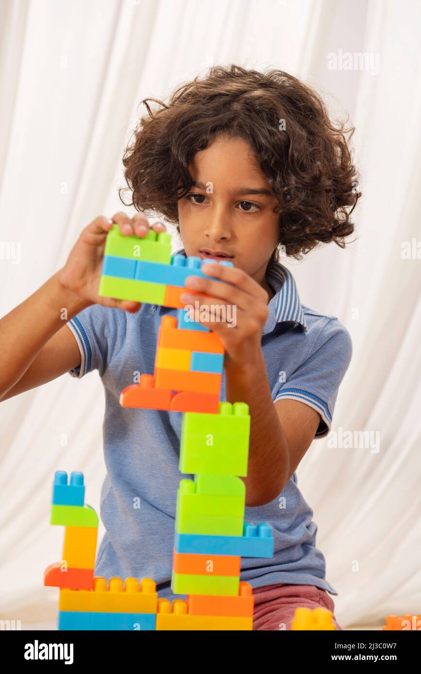 Child boy playing with toy blocks Stock Photo - Alamy