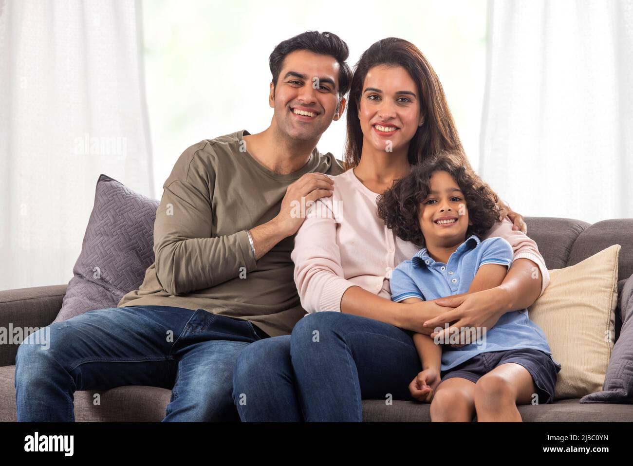 Portrait of a happy parent with kid looking together at camera with ...