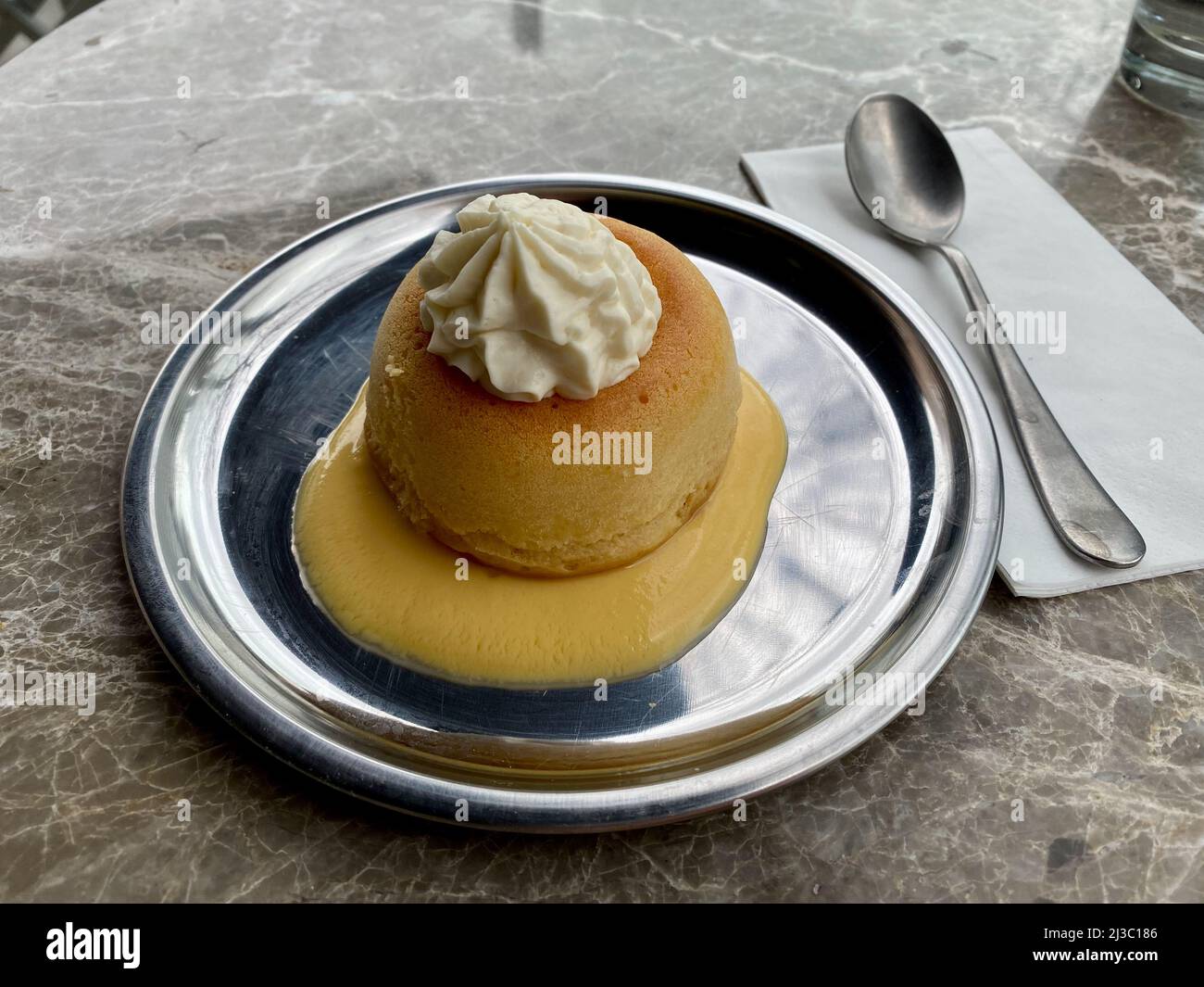 French desssert baba au rhum with whipped cream close up. Traditional ...