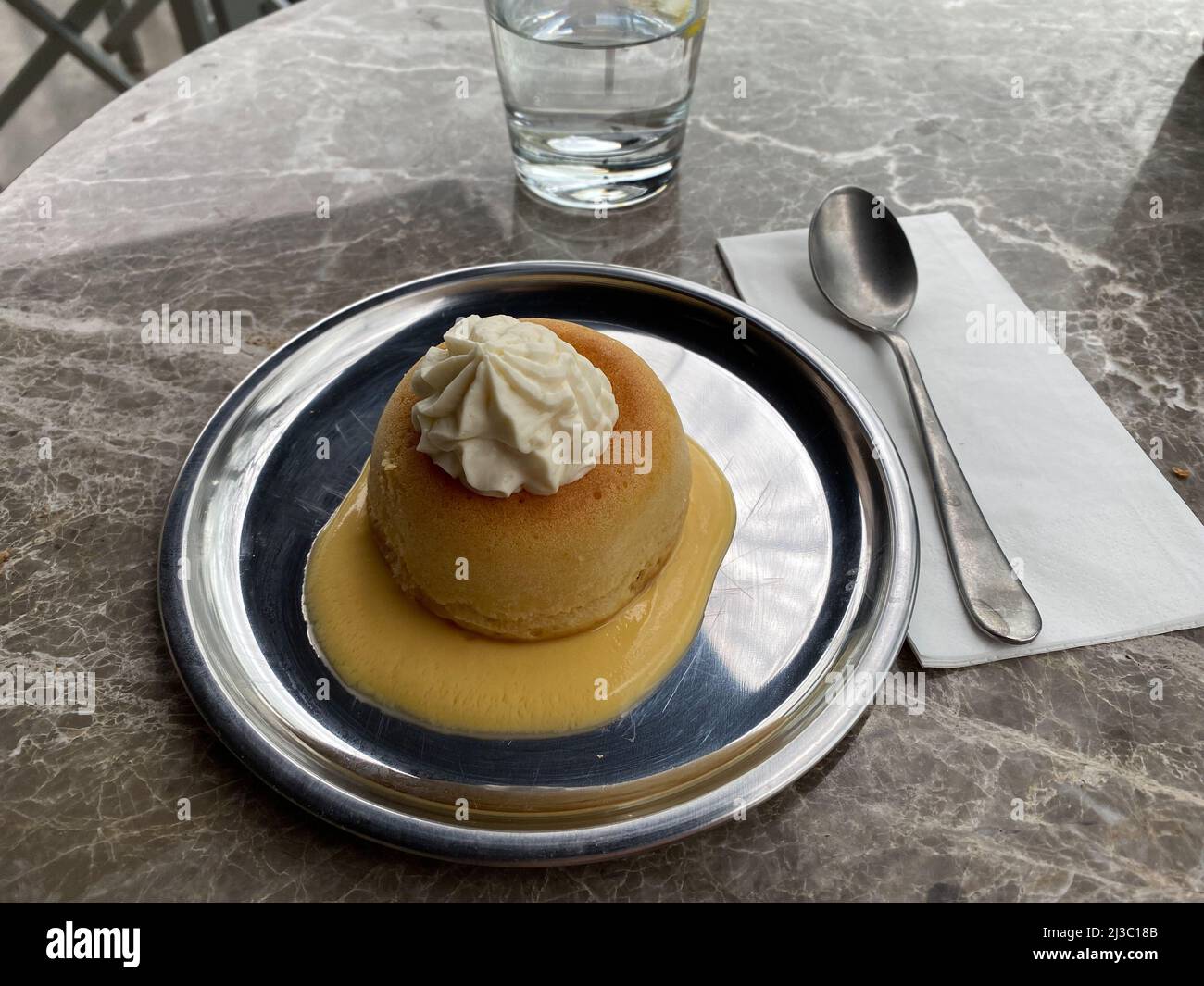 French desssert baba au rhum with whipped cream close up. Traditional ...
