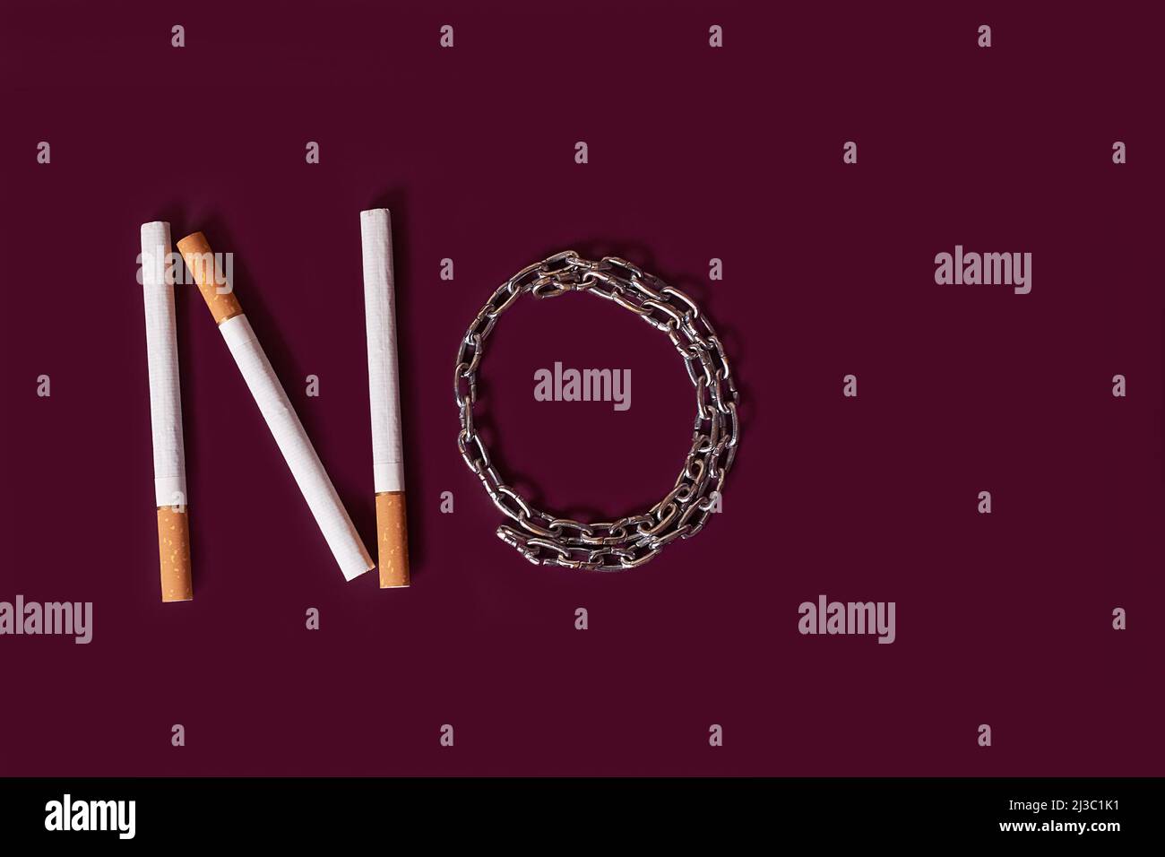 Nicotine addiction. Three cigarettes and a chain in the form of the ...