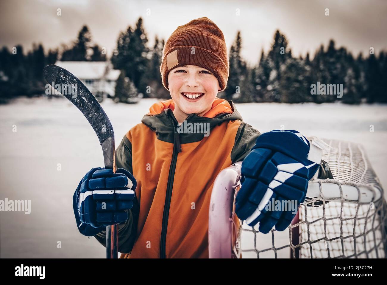 portrait of happy hockey player on a lake Stock Photo - Alamy