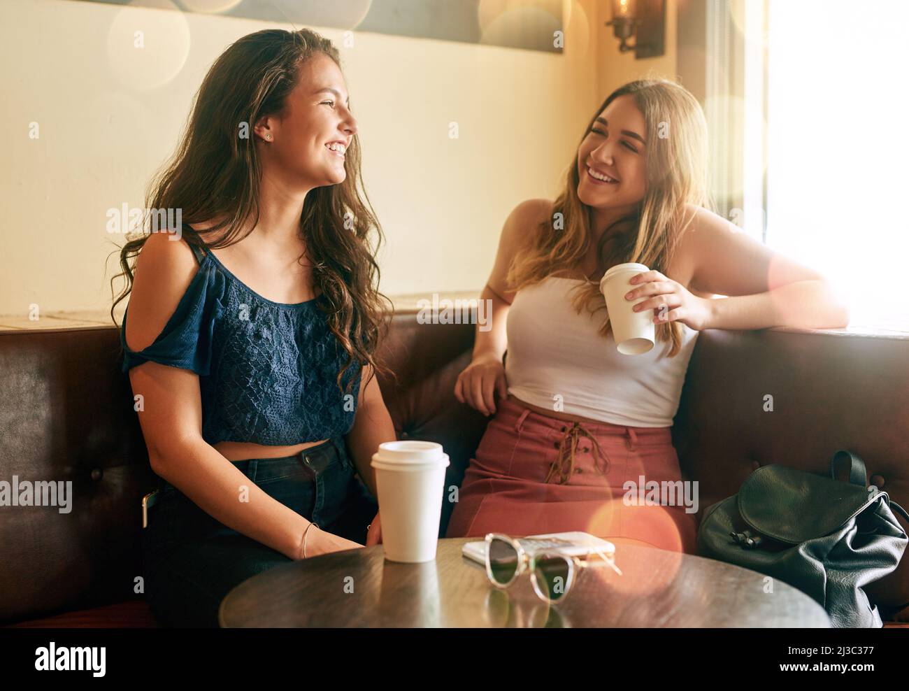 Catching up with her best friend. Cropped shot of two attractive young ...