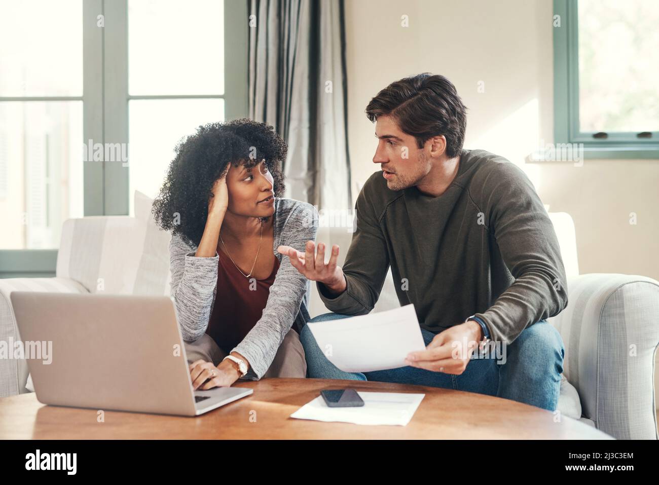 Getting our finances in order. Shot of a young couple going over ...