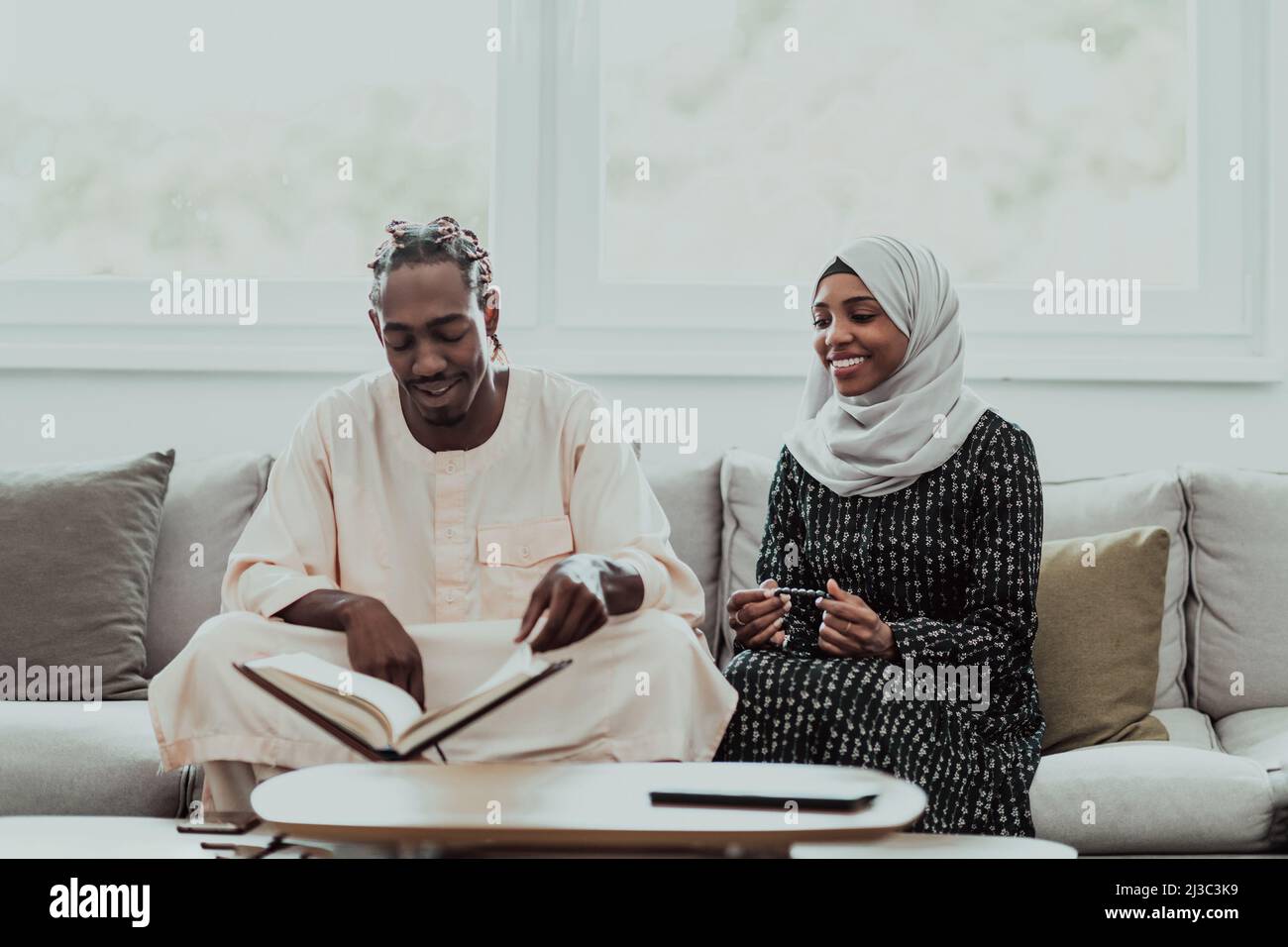 African Muslim couple at home in Ramadan reading Quran holly Islam book ...
