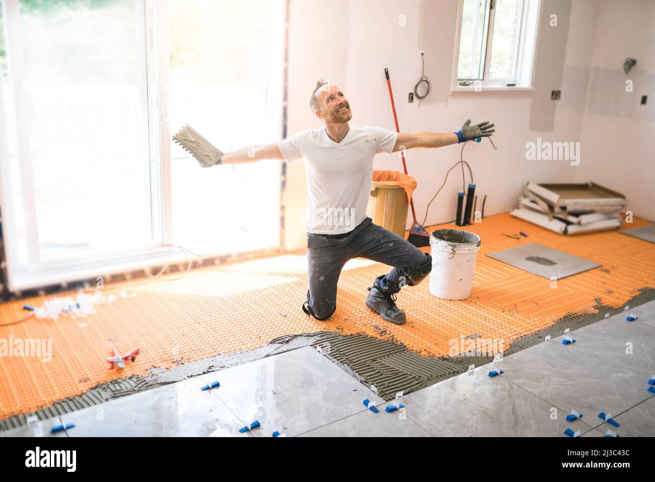 nice handyman install tile on the floor Stock Photo - Alamy