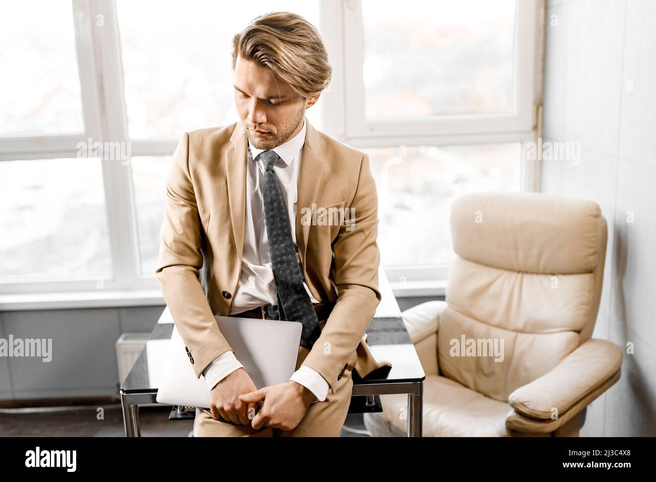 Handsome pensive caucasian businessman hold mobile phone distracted ...