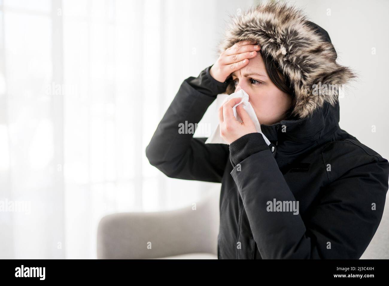 Woman With Warm Clothing Feeling The Cold Inside House on the sofa she ...