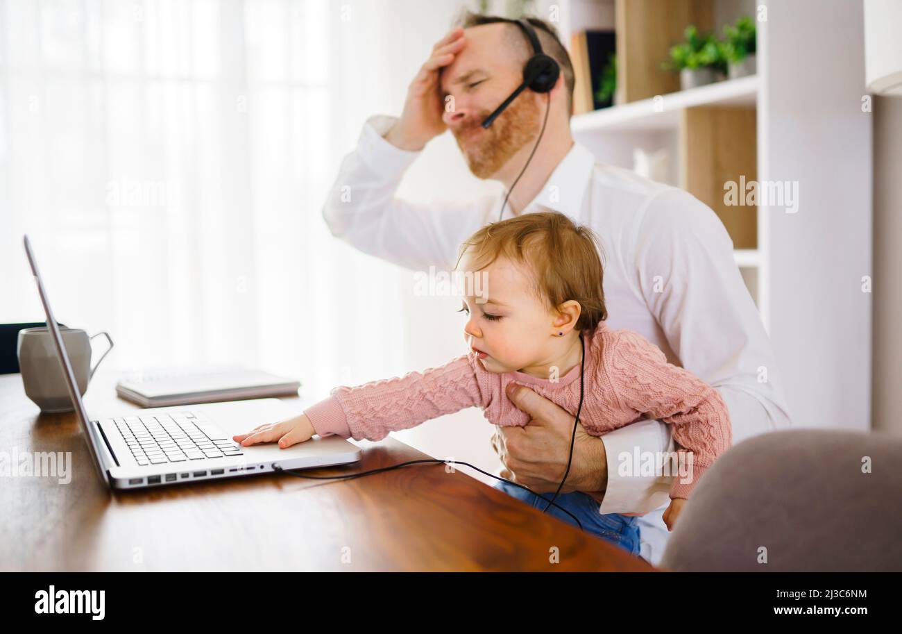 sad and frustrated father in kitchen home office with computer and her ...
