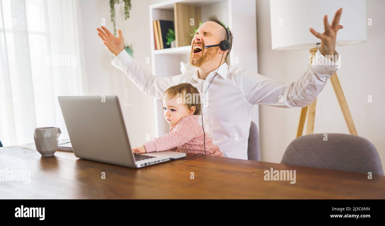 sad and frustrated father in kitchen home office with computer and her ...