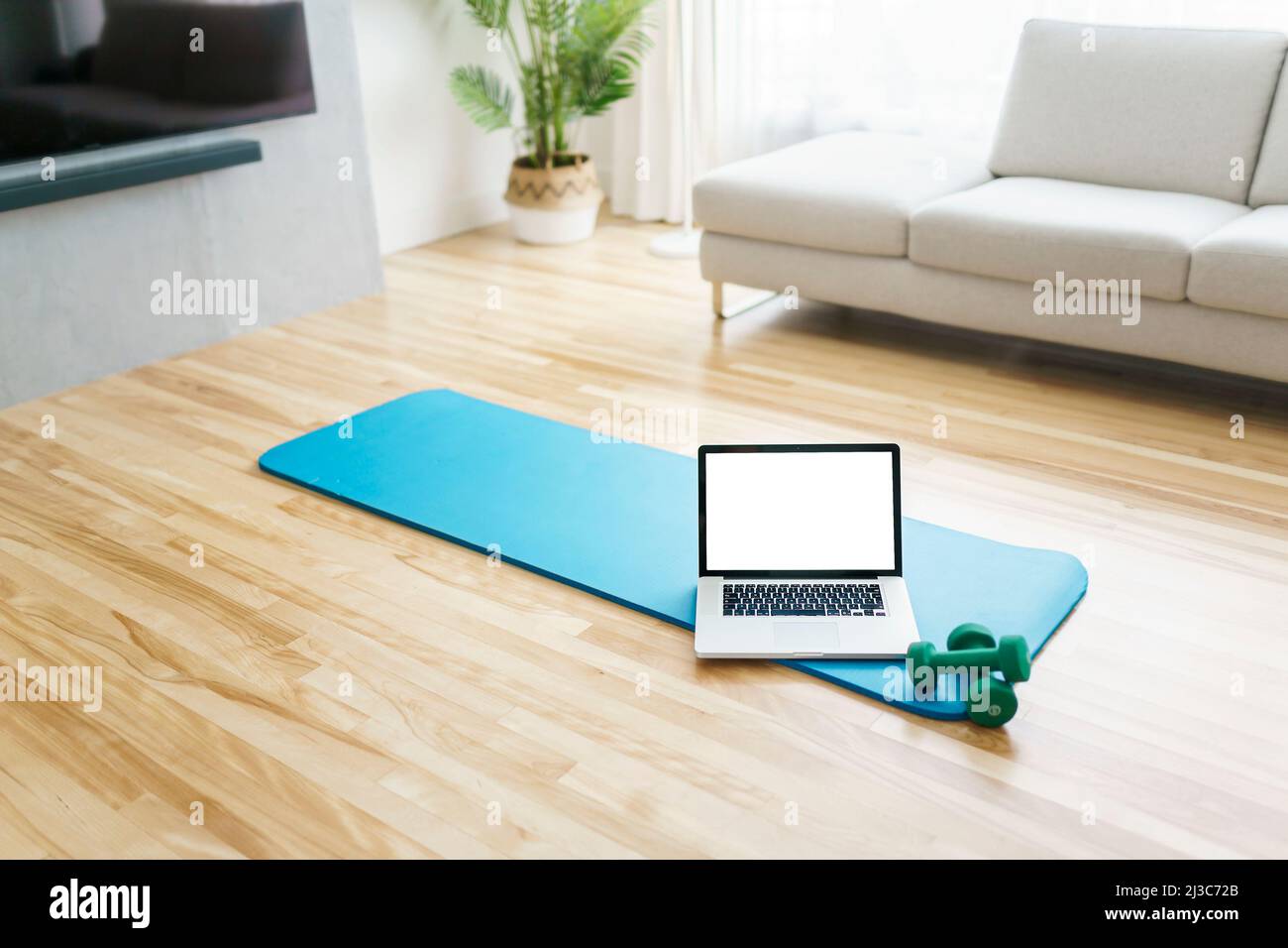 Online workout at home gym concept. Laptop computer on yoga mat on ...