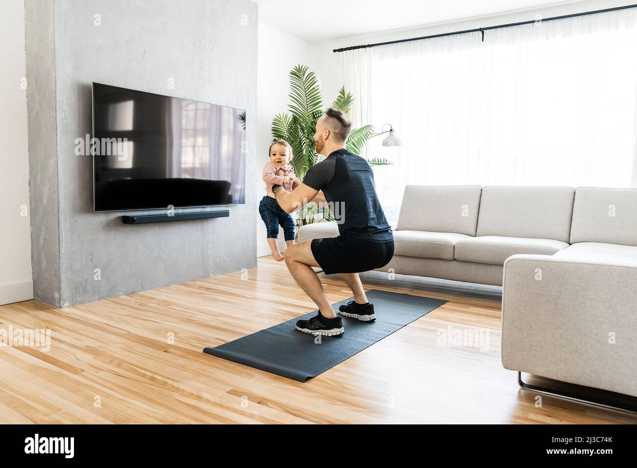 Happy father training with his baby Stock Photo - Alamy