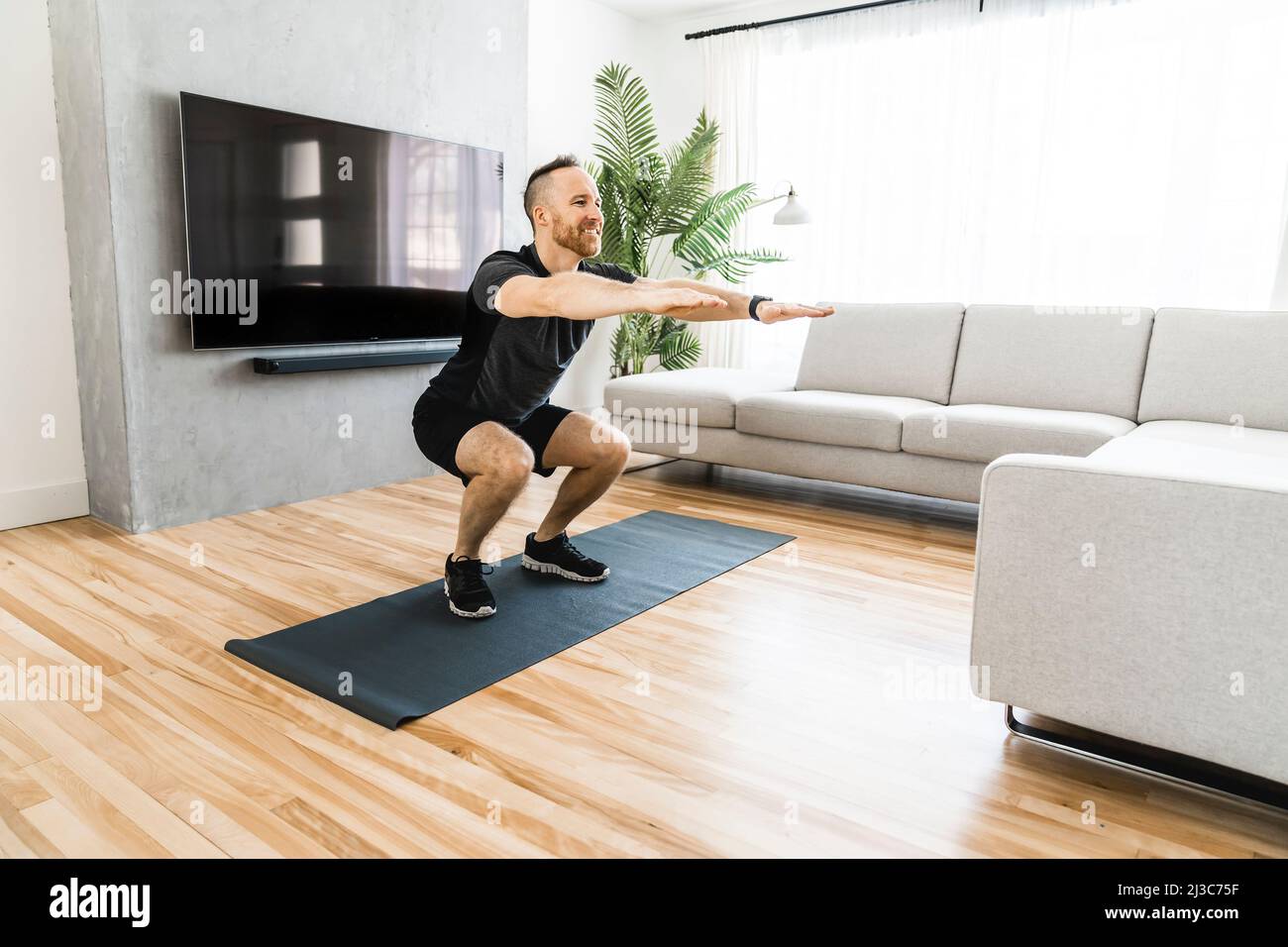 Young man home doing physical hi-res stock photography and images - Alamy