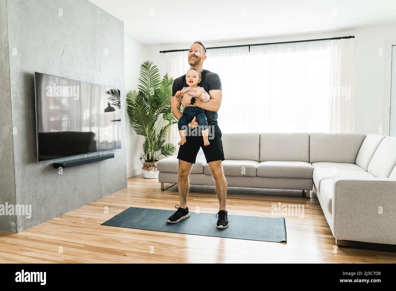 A nice and Happy loving father training with his baby Stock Photo - Alamy