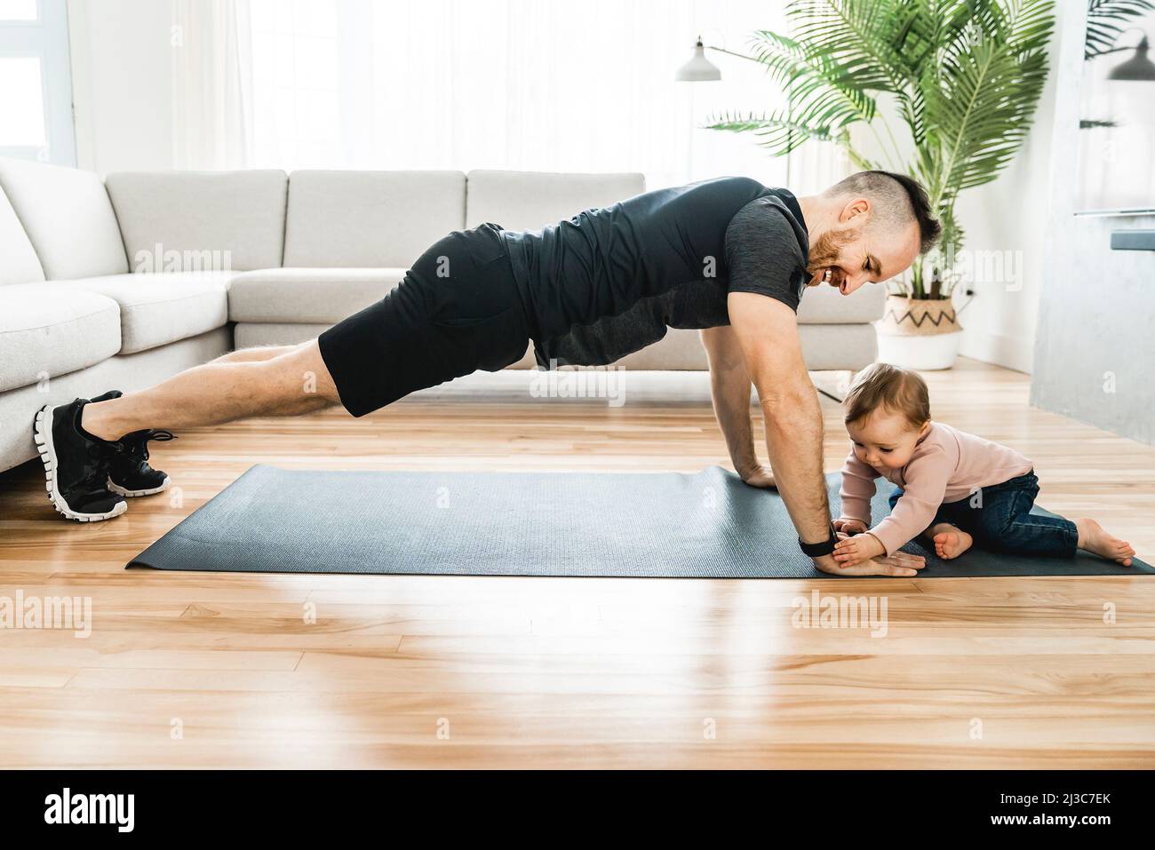Nice father training with his baby at home Stock Photo - Alamy