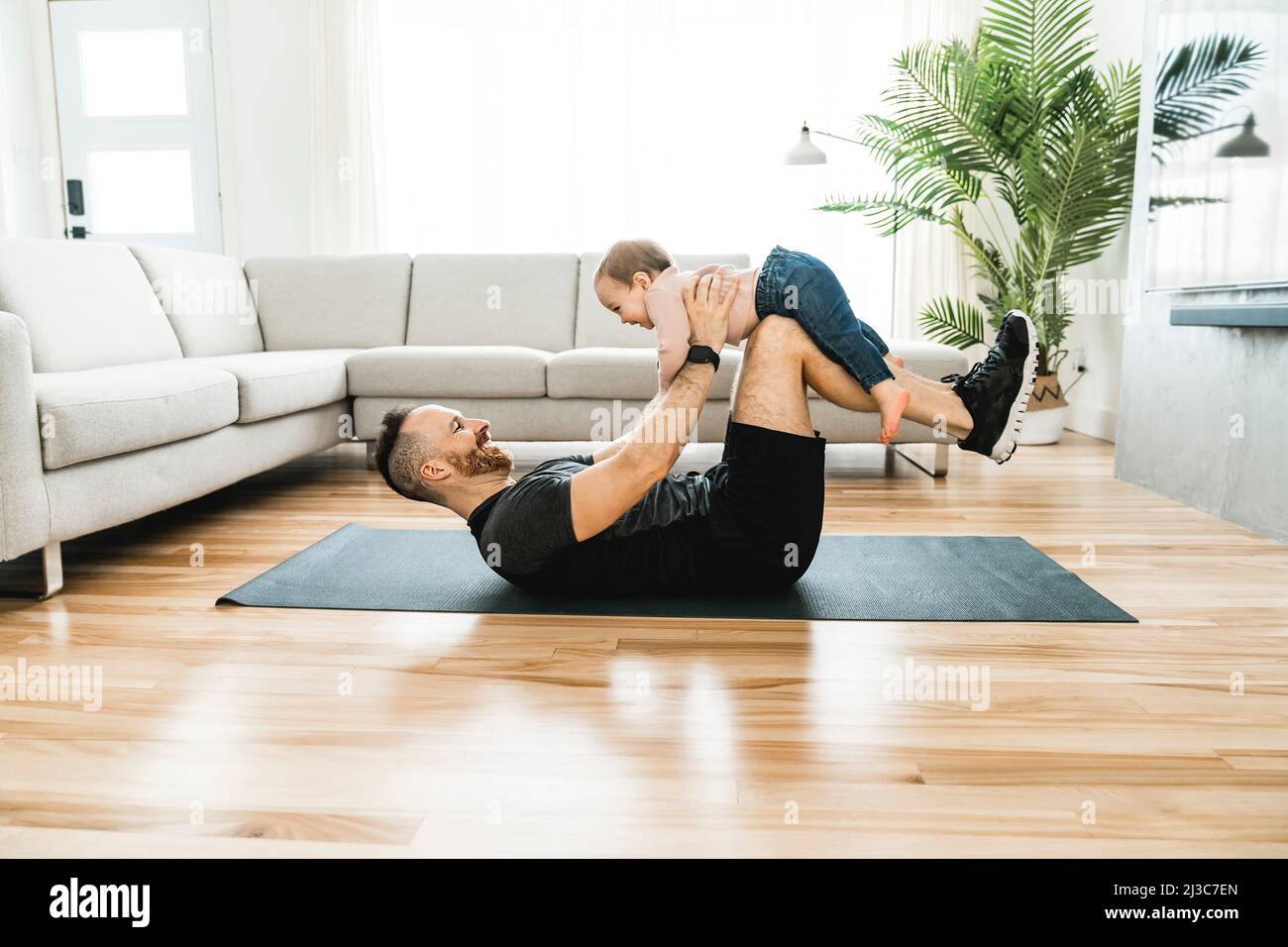 Nice father training with his baby at home Stock Photo - Alamy