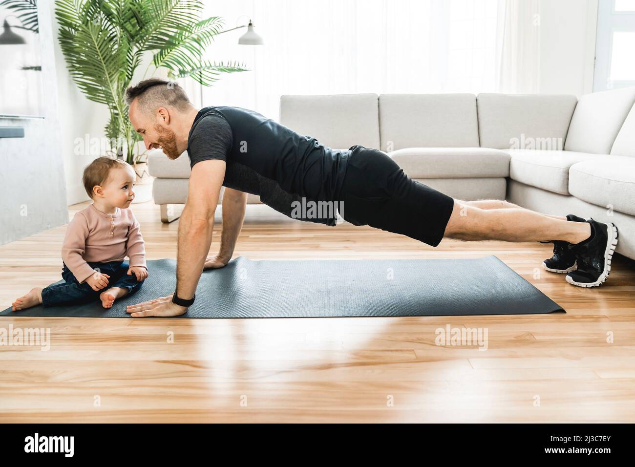 Nice father training with his baby at home Stock Photo - Alamy
