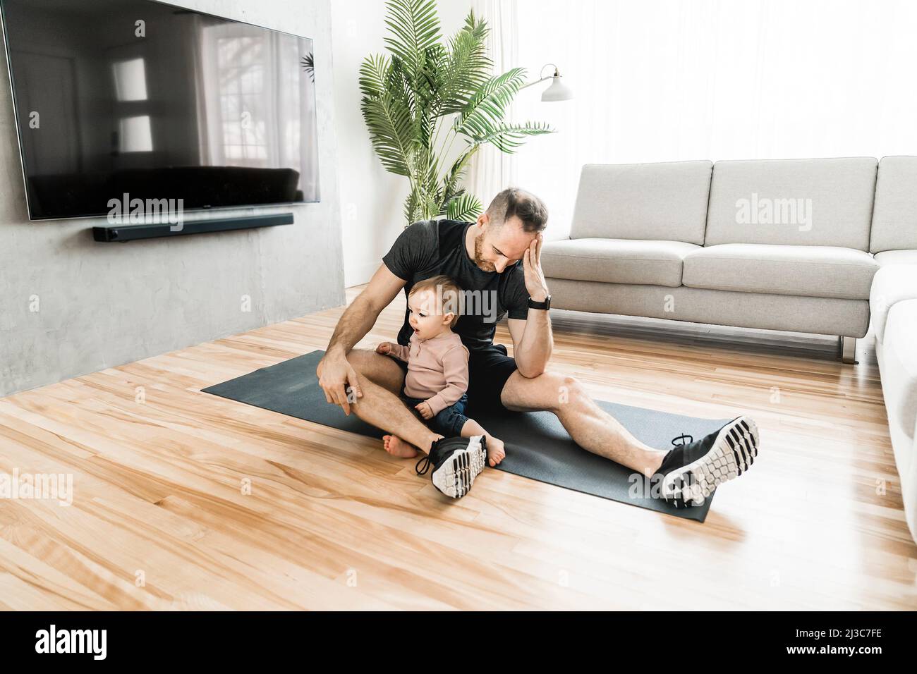 Nice father training with his baby at home Stock Photo - Alamy