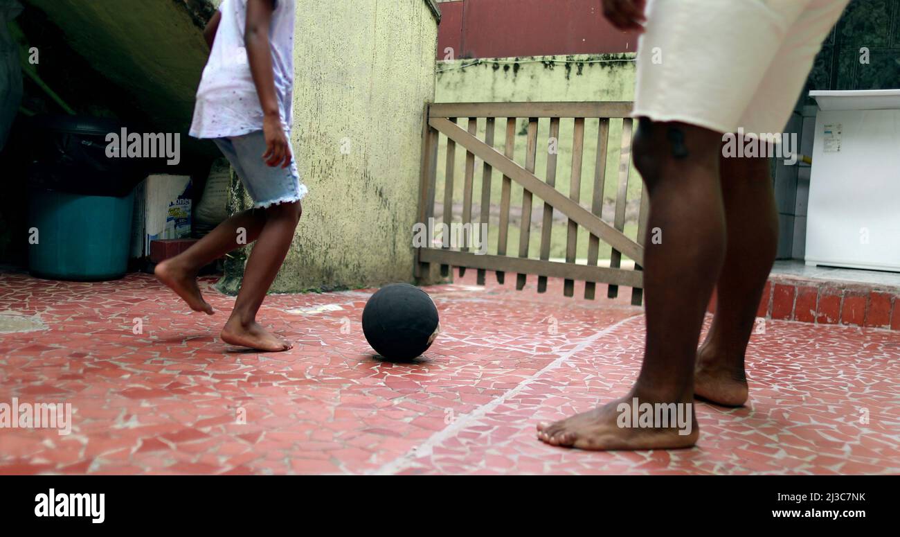 African father and son playing football. Parent and child bonding ...