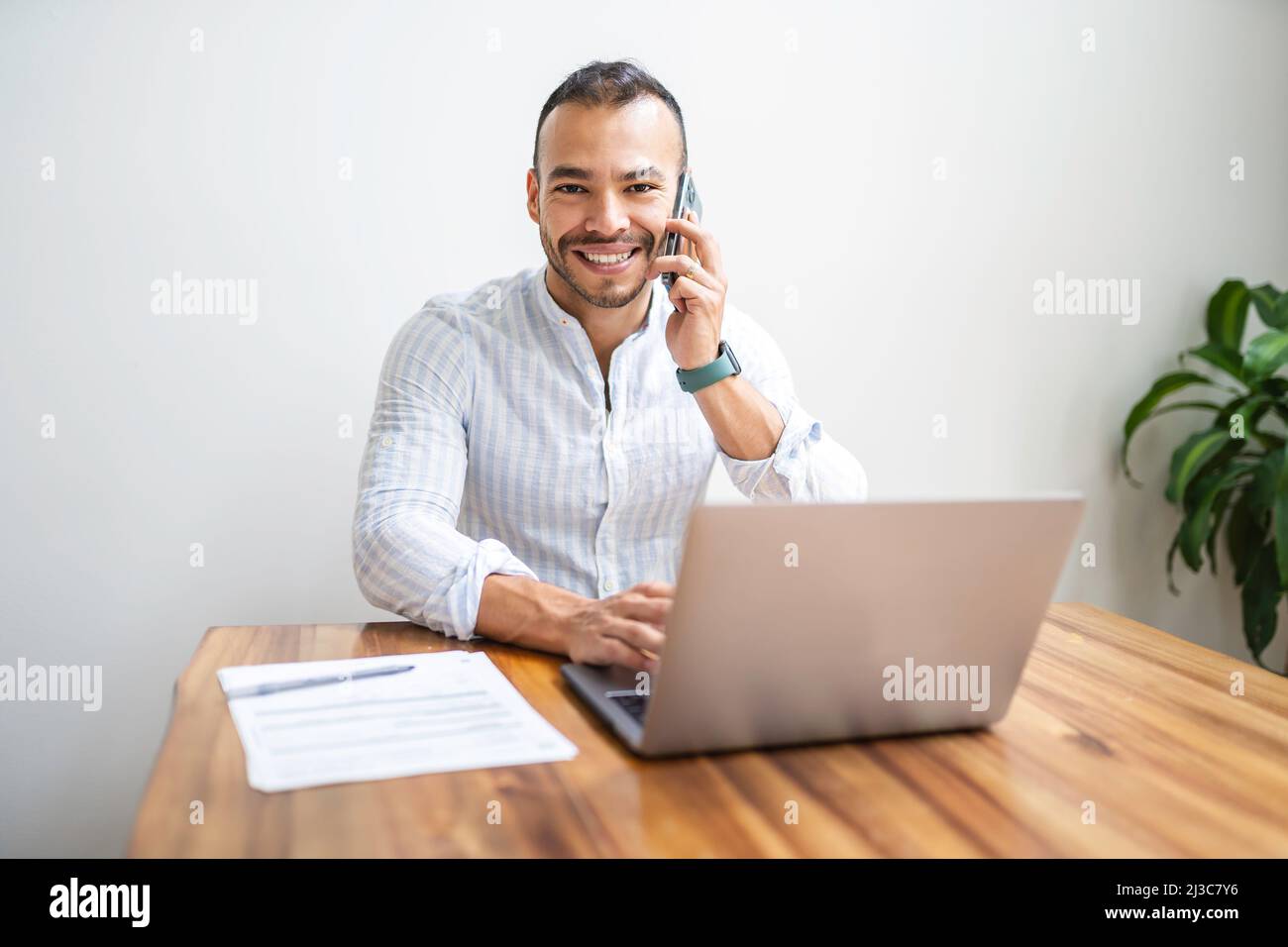 Portrait young mexican attractive businessman working at modern home ...