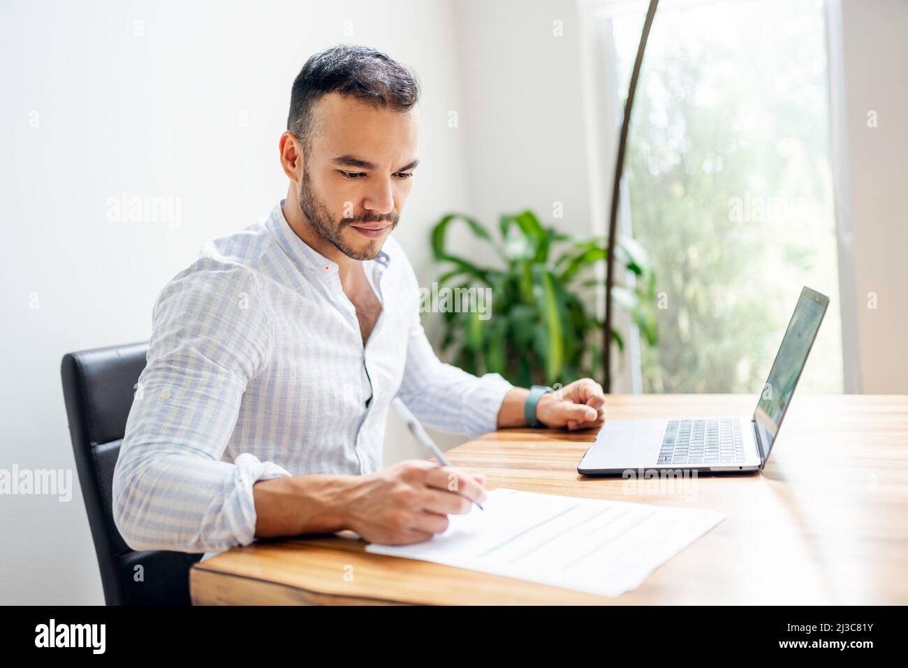 Portrait young mexican attractive businessman working at modern home ...