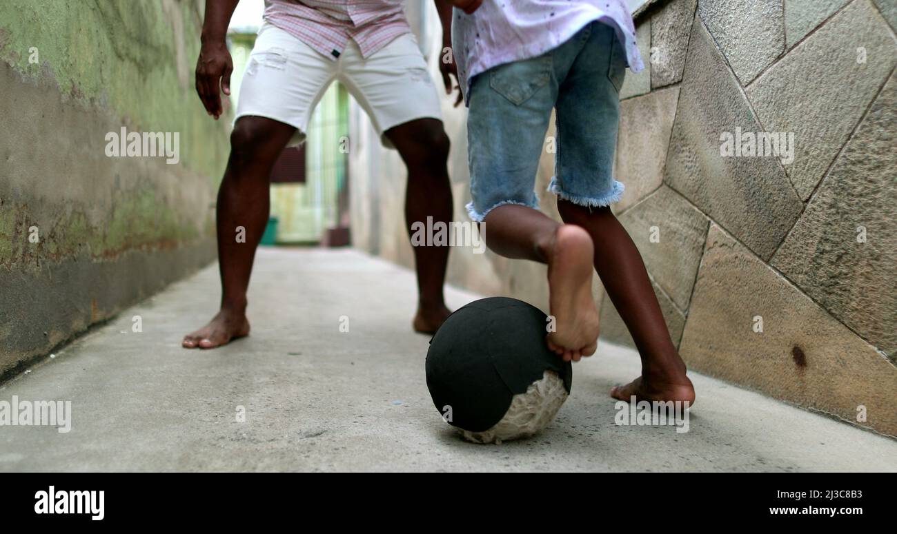 Father and son playing football together. African parent bonding with ...
