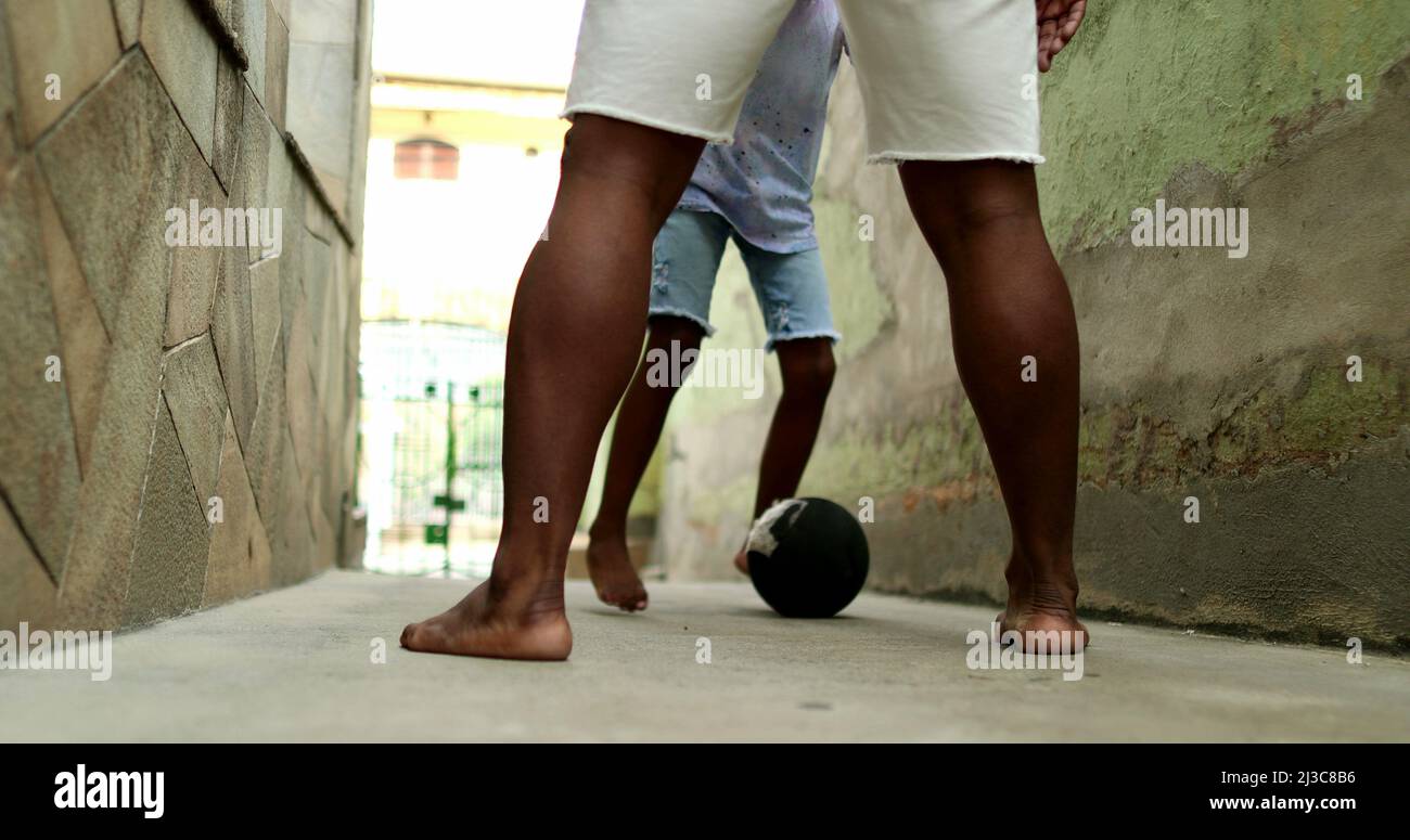 Father and son playing football together. African parent bonding with ...