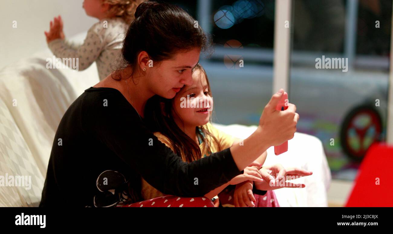 Mother holding phone talking video with family member, distant calling ...