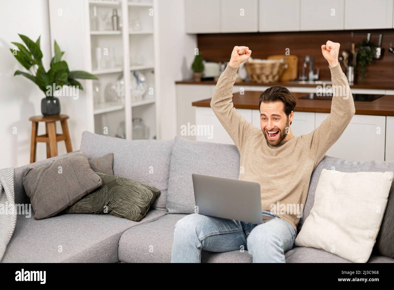 Excited caucasian businessman looking at the laptop screen and ...