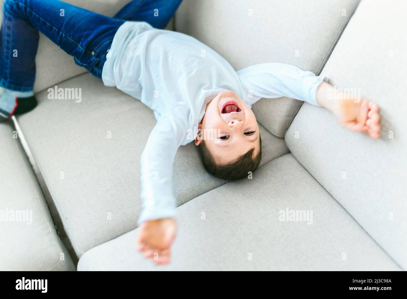 Little crazy boy on living room look like hyperactive Stock Photo - Alamy