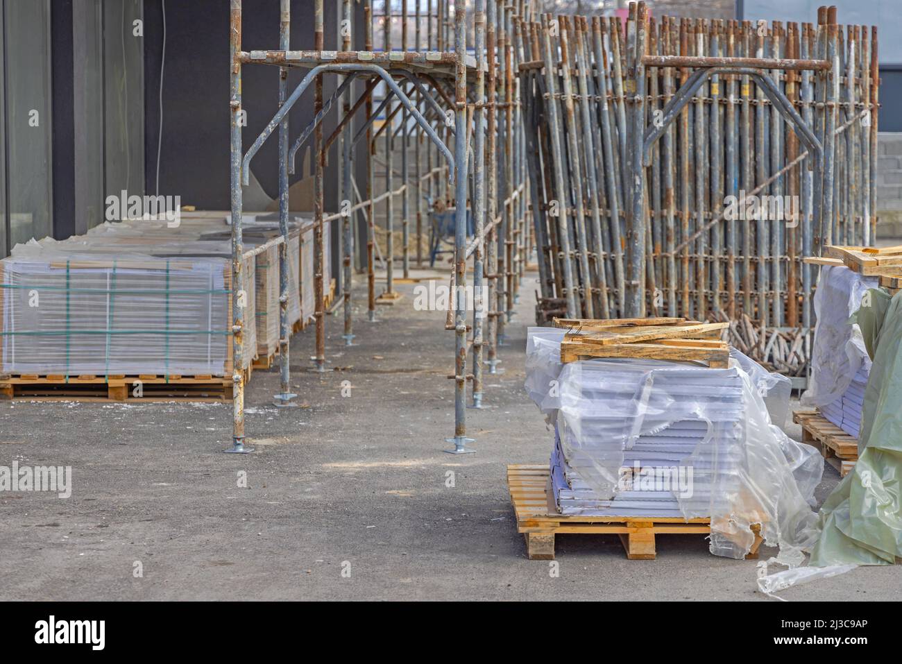 Boxes of Material Pallets at Construction Site Scaffolding Preparation ...