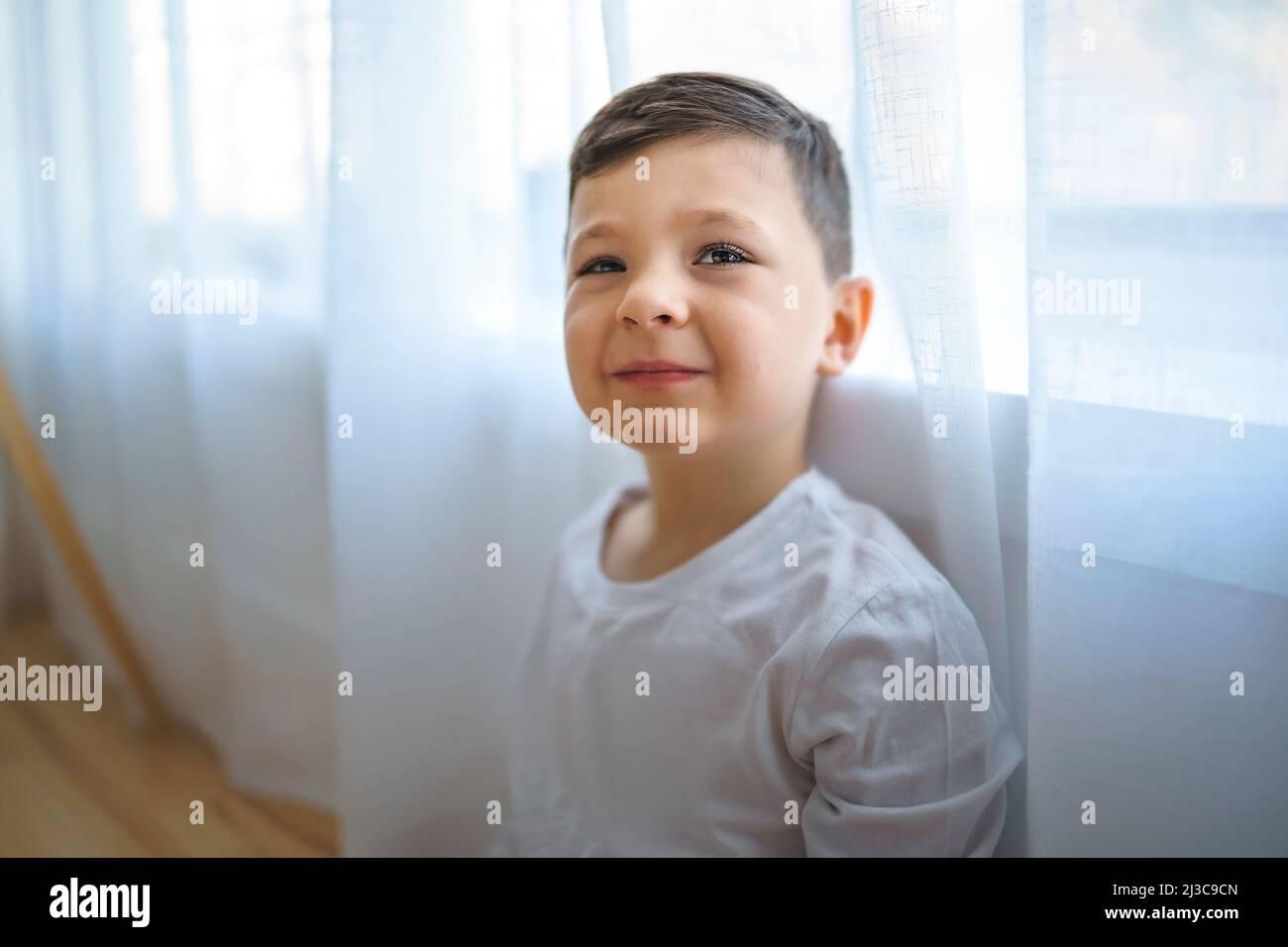 kid on the living room at home close to a window Stock Photo - Alamy