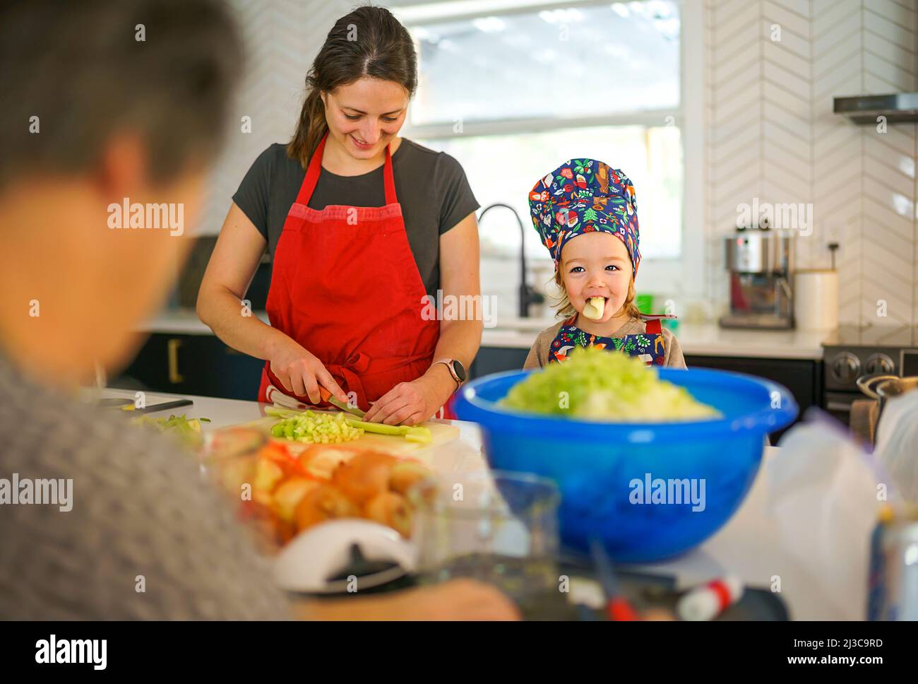 Child helping parent cook hi-res stock photography and images - Alamy