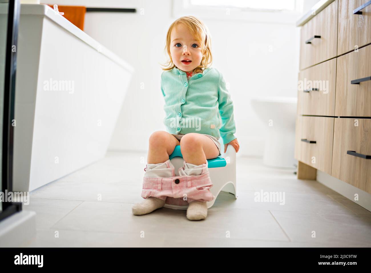 cute child girl sitting on chamberpot on the bathroom Stock Photo - Alamy