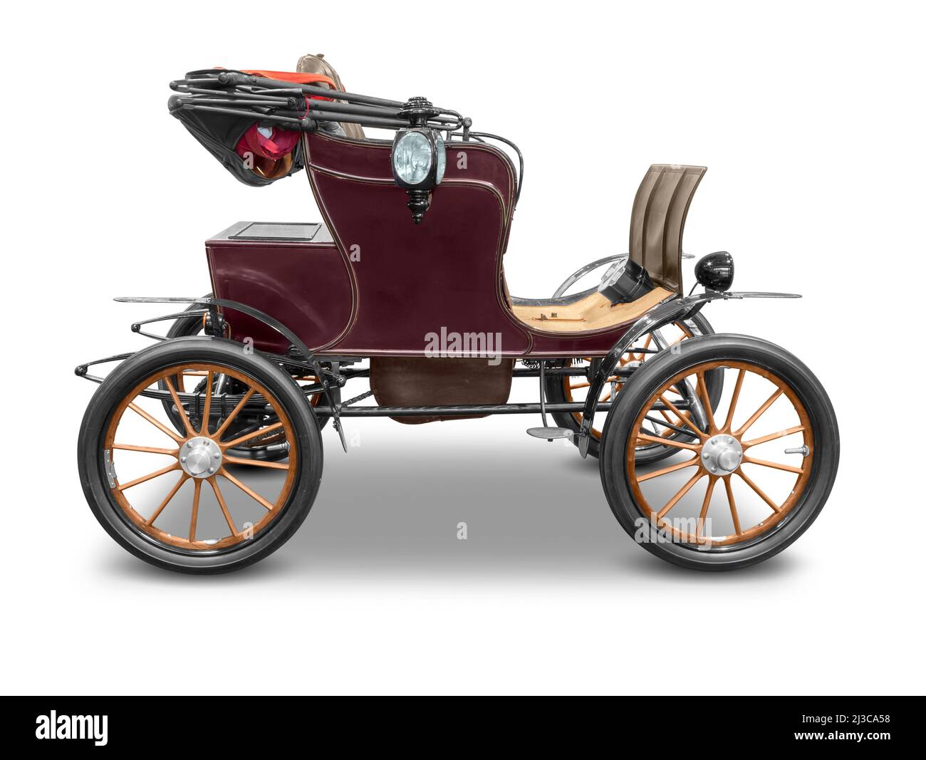 Sideways shot of a old historic electric car isolated in white back ...