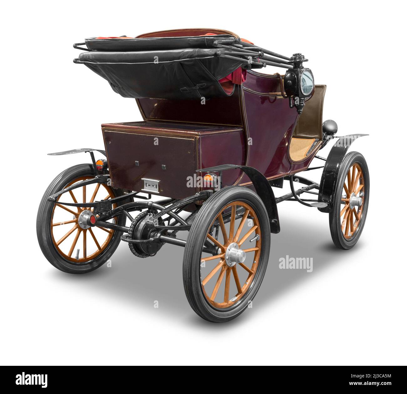 Rear view of a old historic electric car isolated in white back with ...