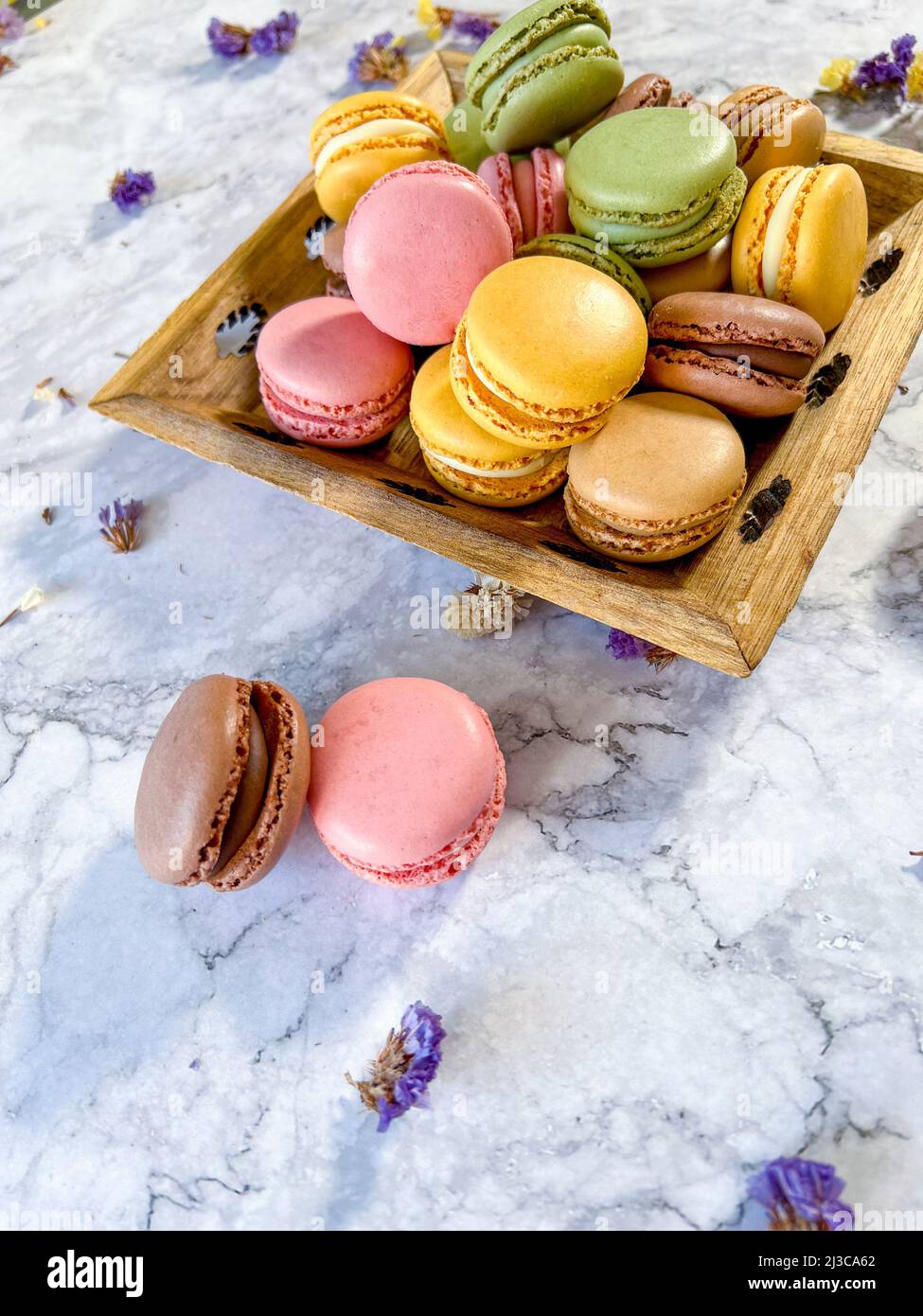 Colorful french Macaroons on white marble background seen from above ...