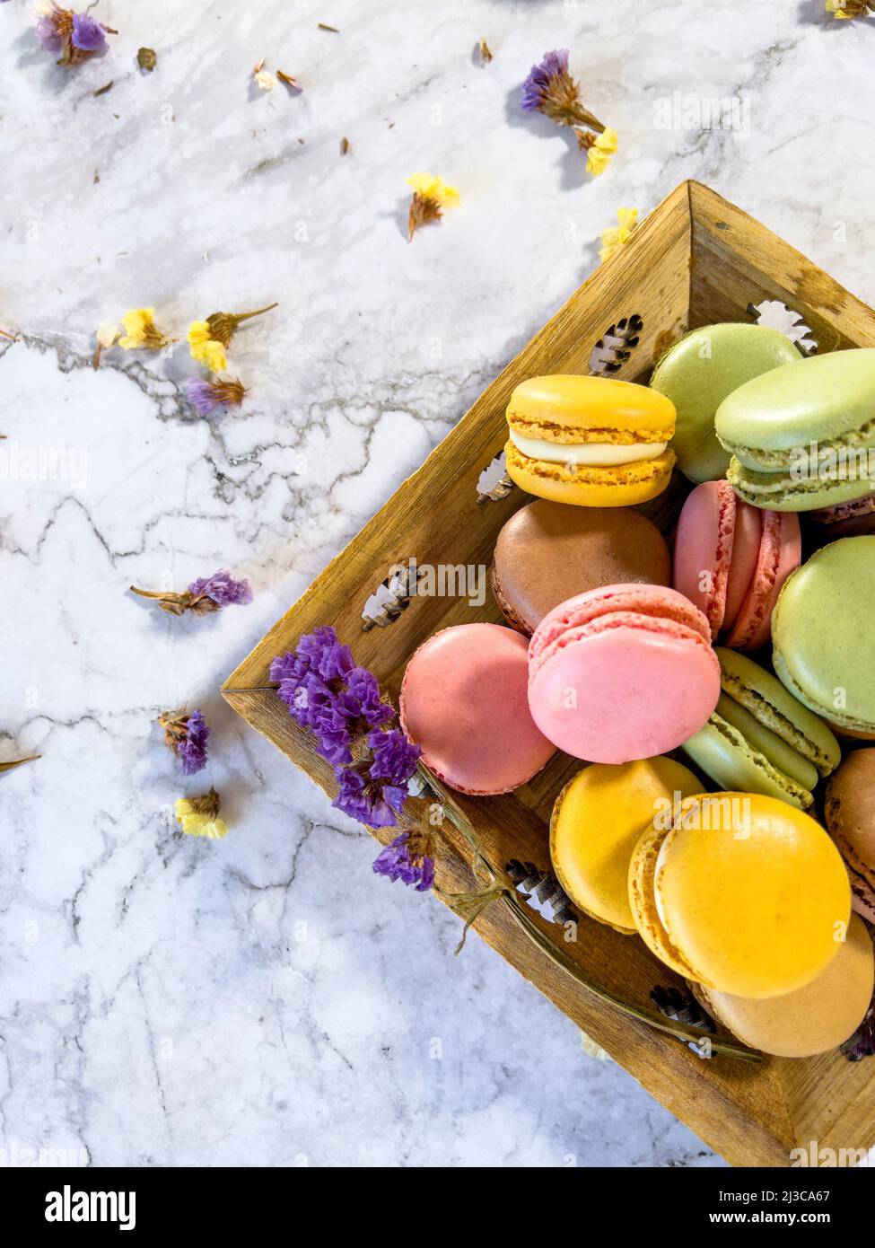 Colorful french Macaroons on white marble background seen from above ...