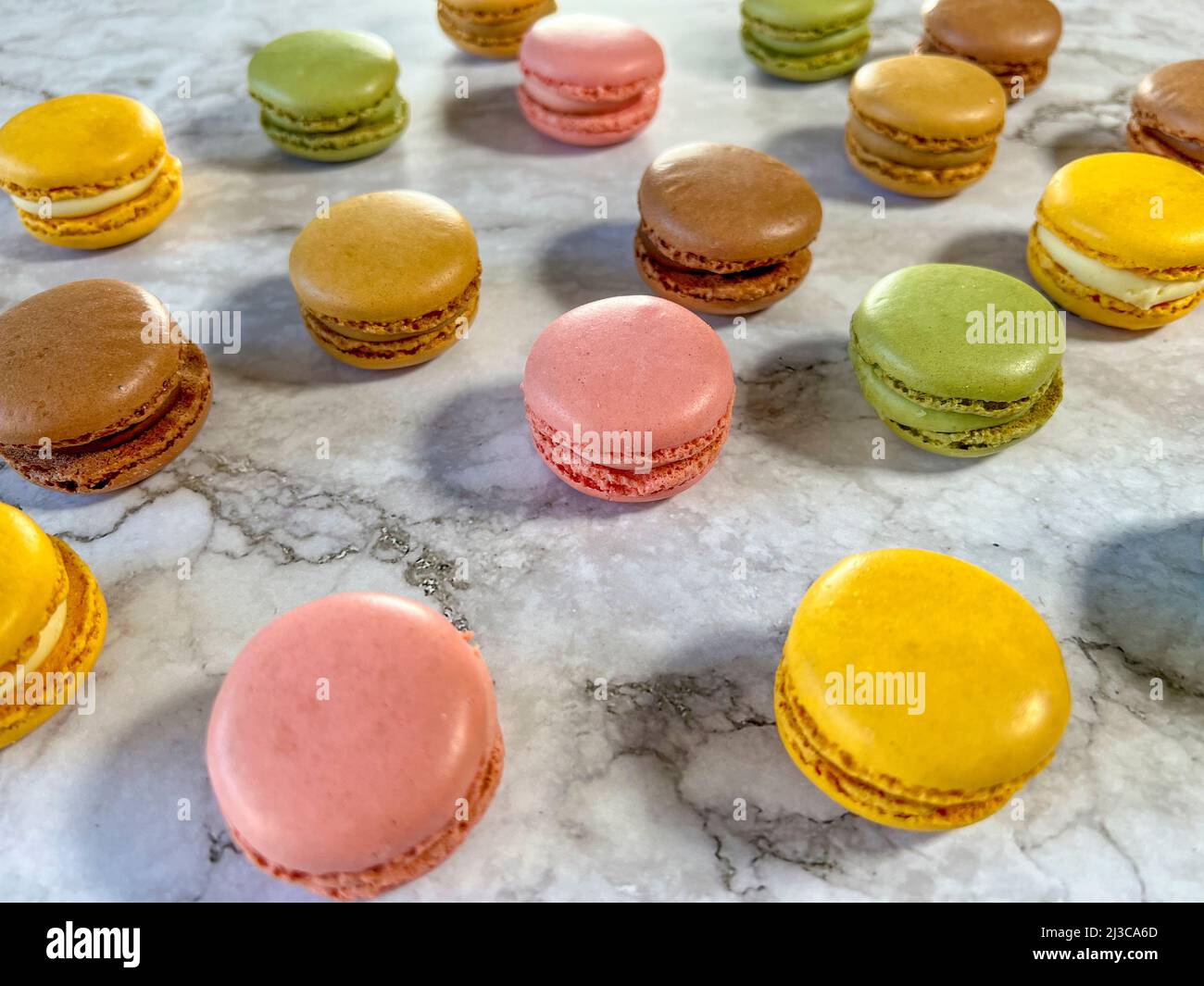 Colorful french Macaroons on white marble background seen from above ...