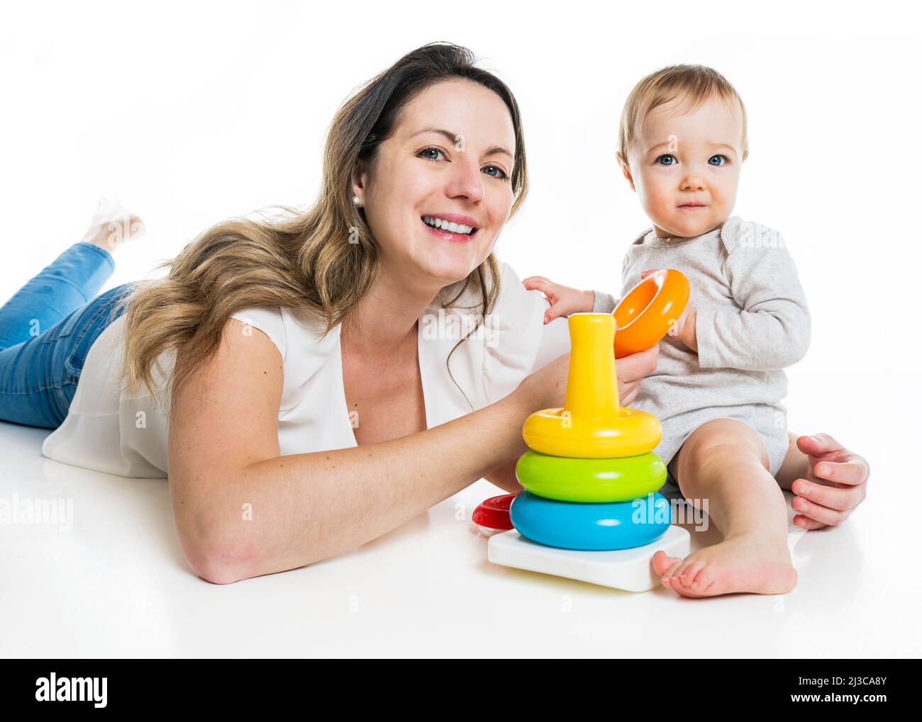 baby girl and mother playing together with color toy Stock Photo - Alamy