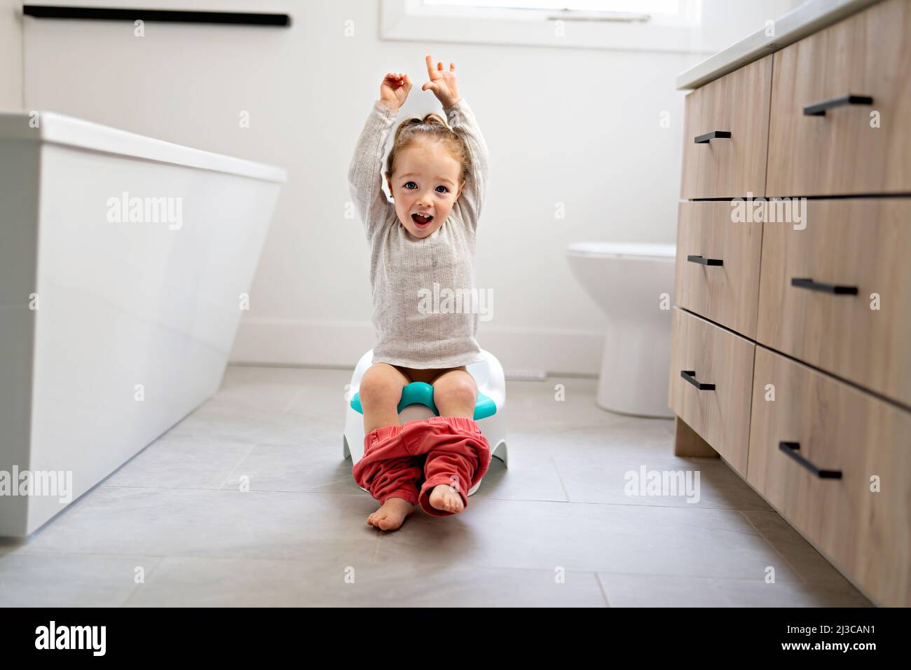 Adorable young baby child sitting and learning how to use the toilet ...