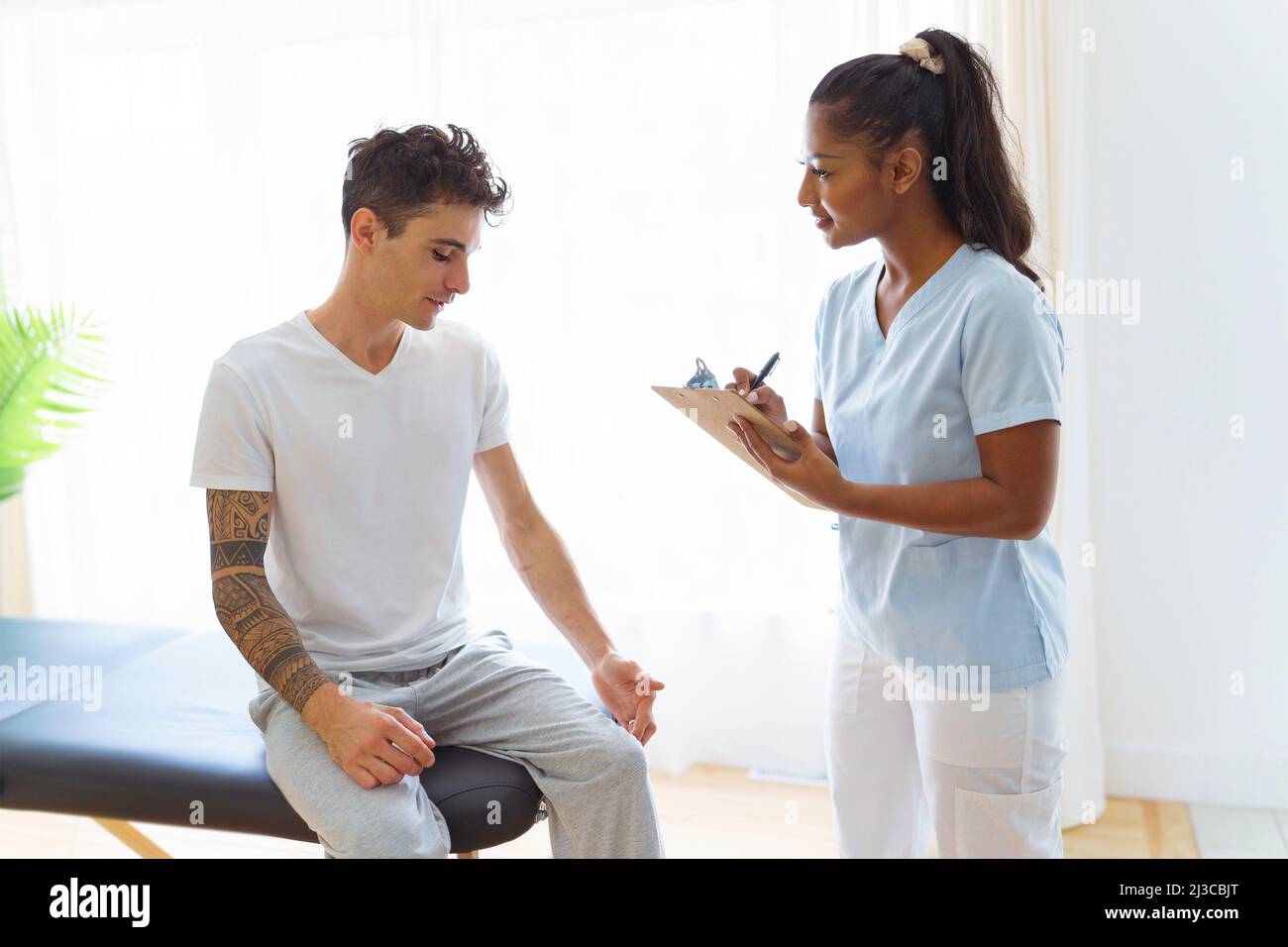 black rehabilitation woman physiotherapy at physio clinic with client Stock Photo - Alamy