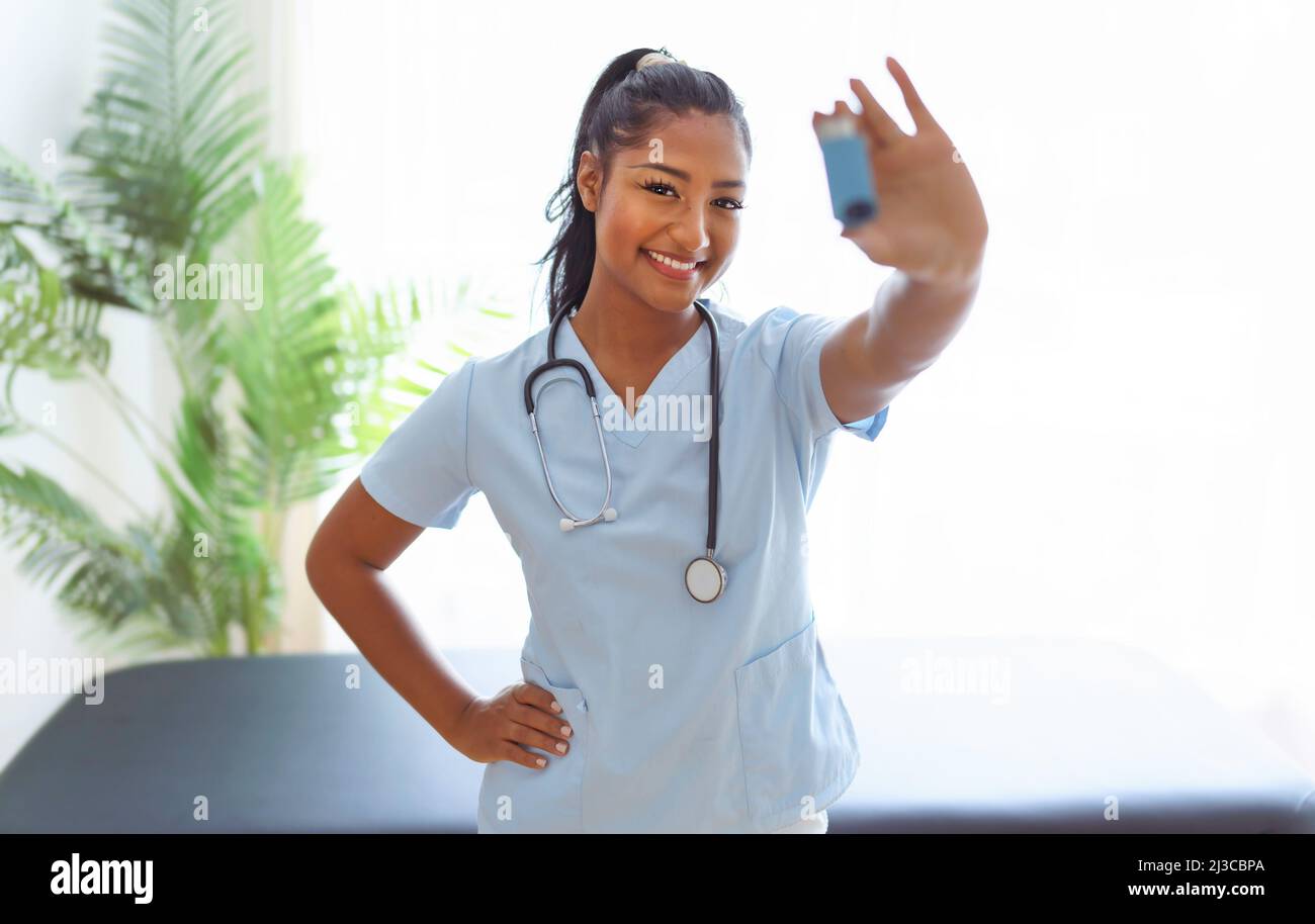 Young doctor holding asthma inhaler in clinic Stock Photo - Alamy