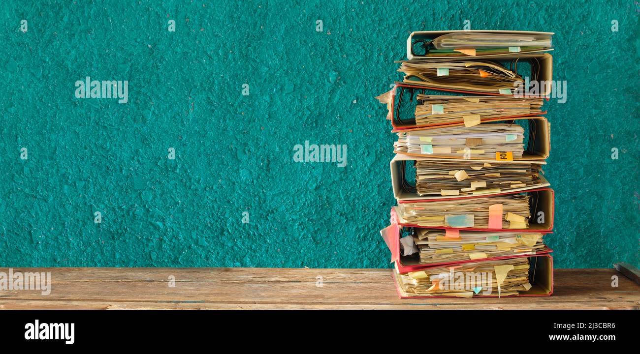 stack of messy file folders,red tape, bureaucracy,aministration ...